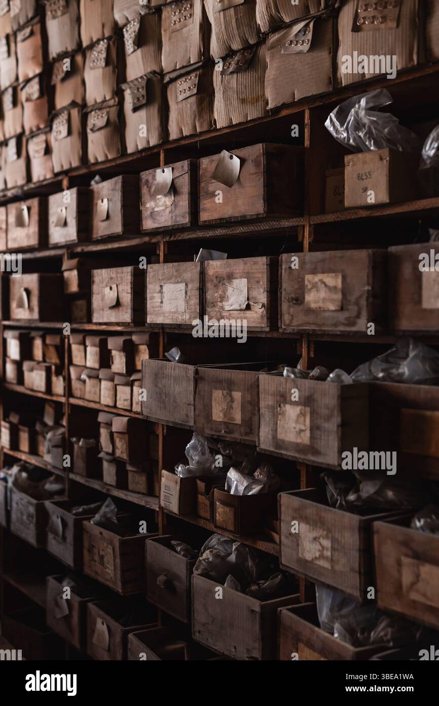 A close-up perspective of a storage area with countless wooden boxes ...