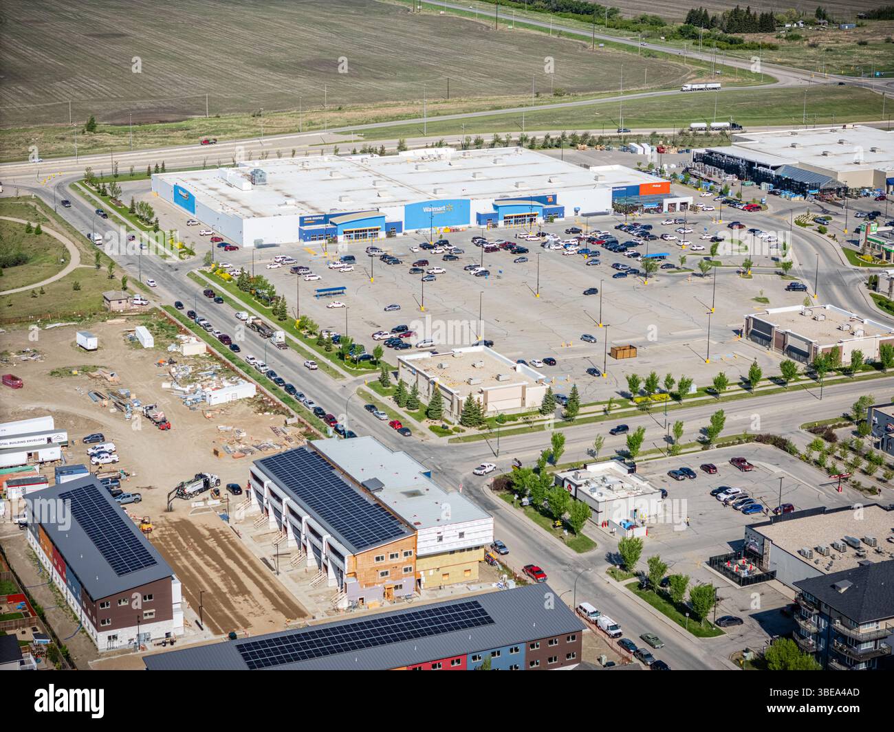Large Walmart store is surrounded by a parking lot. The parking lot is ...