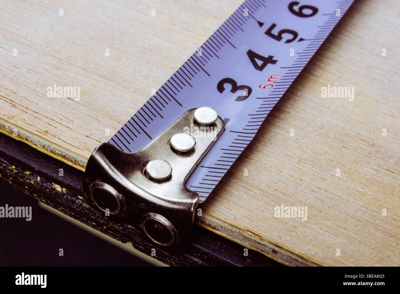 Tape measure measuring plywood DIY Stock Photo - Alamy