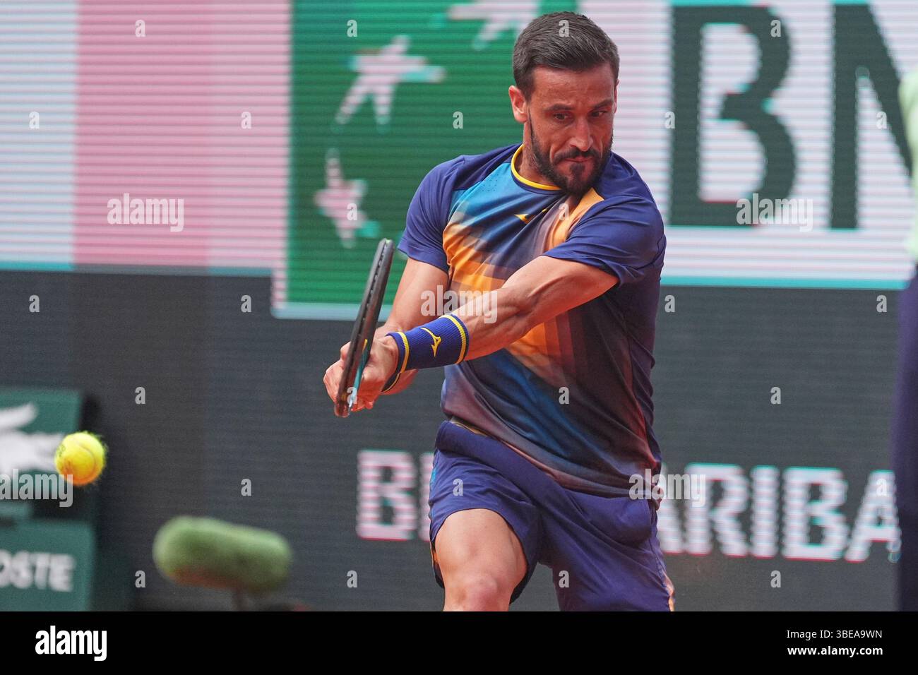 Bosnia and Herzegovina's Damir Dzumhur returns the ball to France's Giovanni Mpetshi Perricard ...