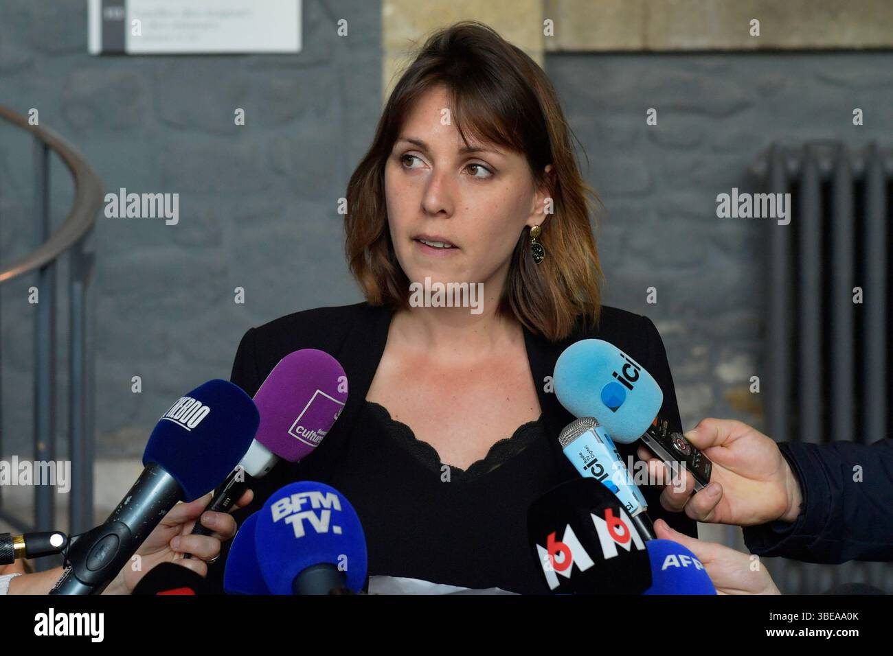 Manon Lemoine, spokeswoman for victims, answers reporters after Joel Le ...