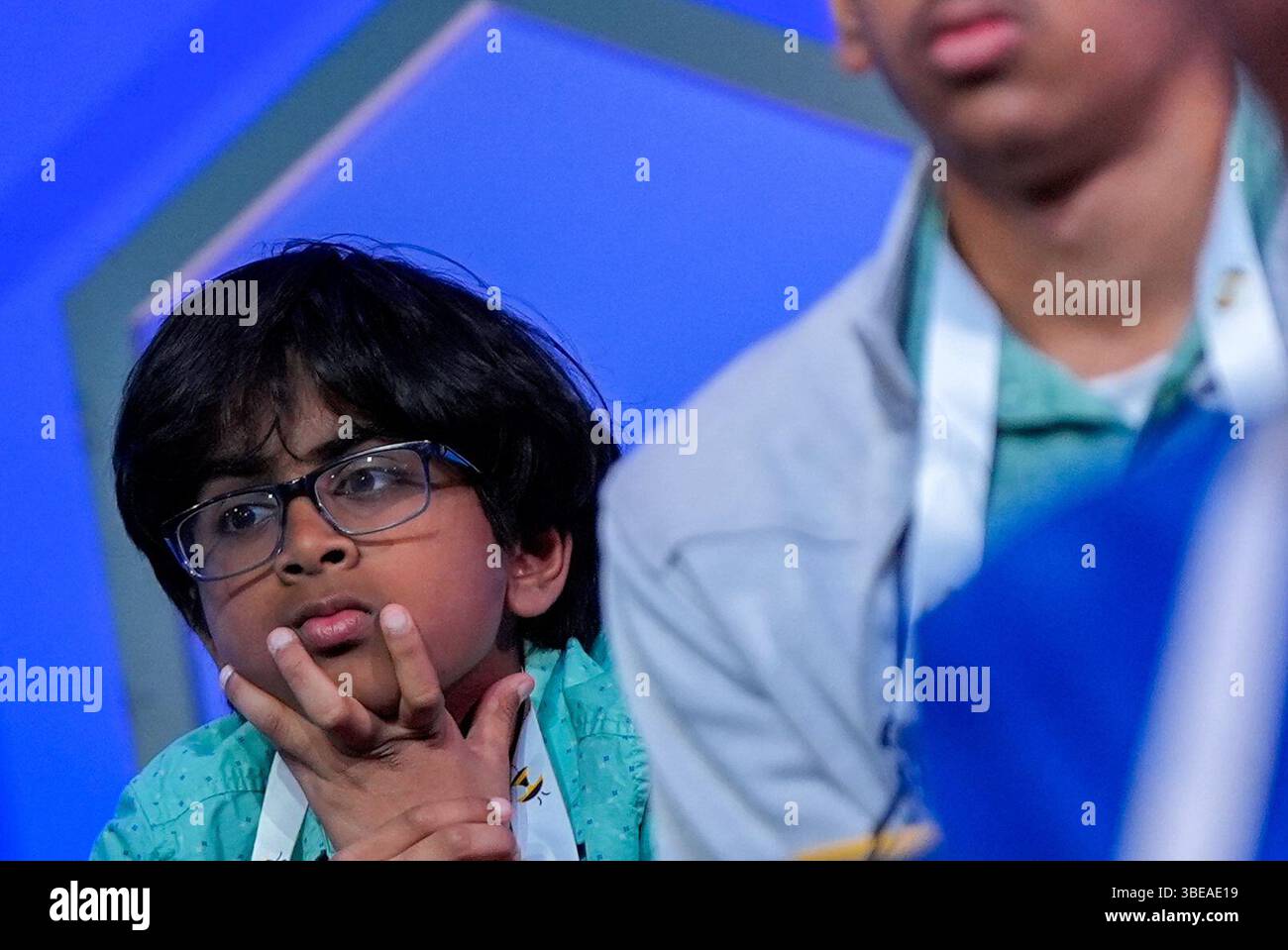 Vikyath Tanamala, 10, of Leesburg, Va., watches spellers compete during ...