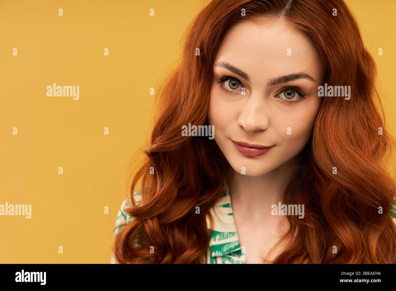 A beautiful young woman showcases her stunning red hair and captivating ...