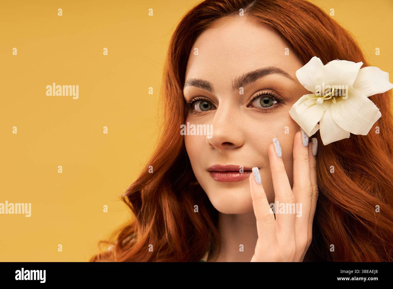 Radiant woman enhances her beauty with a delicate flower while ...