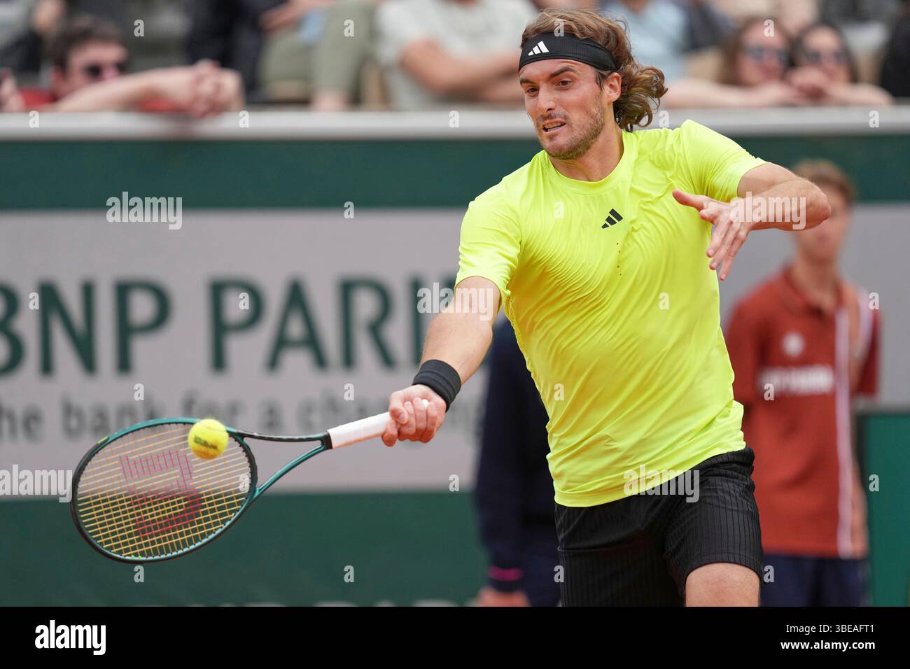 Greece's Stefanos Tsitsipas returns the ball to Italy's Matteo Gigante ...