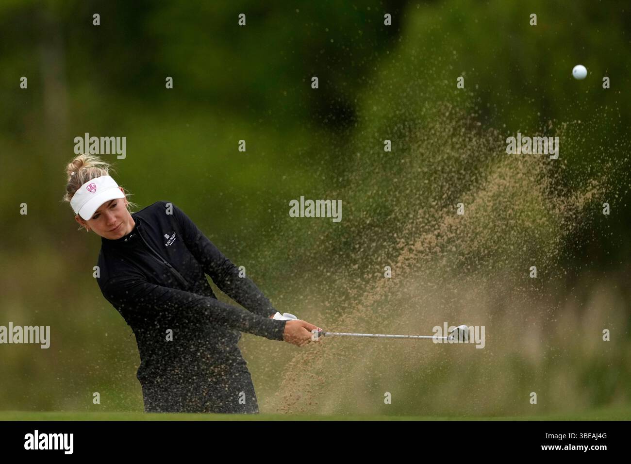 Abbey Daniel hits from the third fairway bunker during a practice round ...