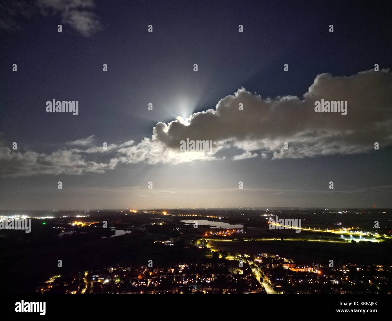 Aerial night view of the supermoon breaking through clouds above Lady Bay, West Bridgford ...