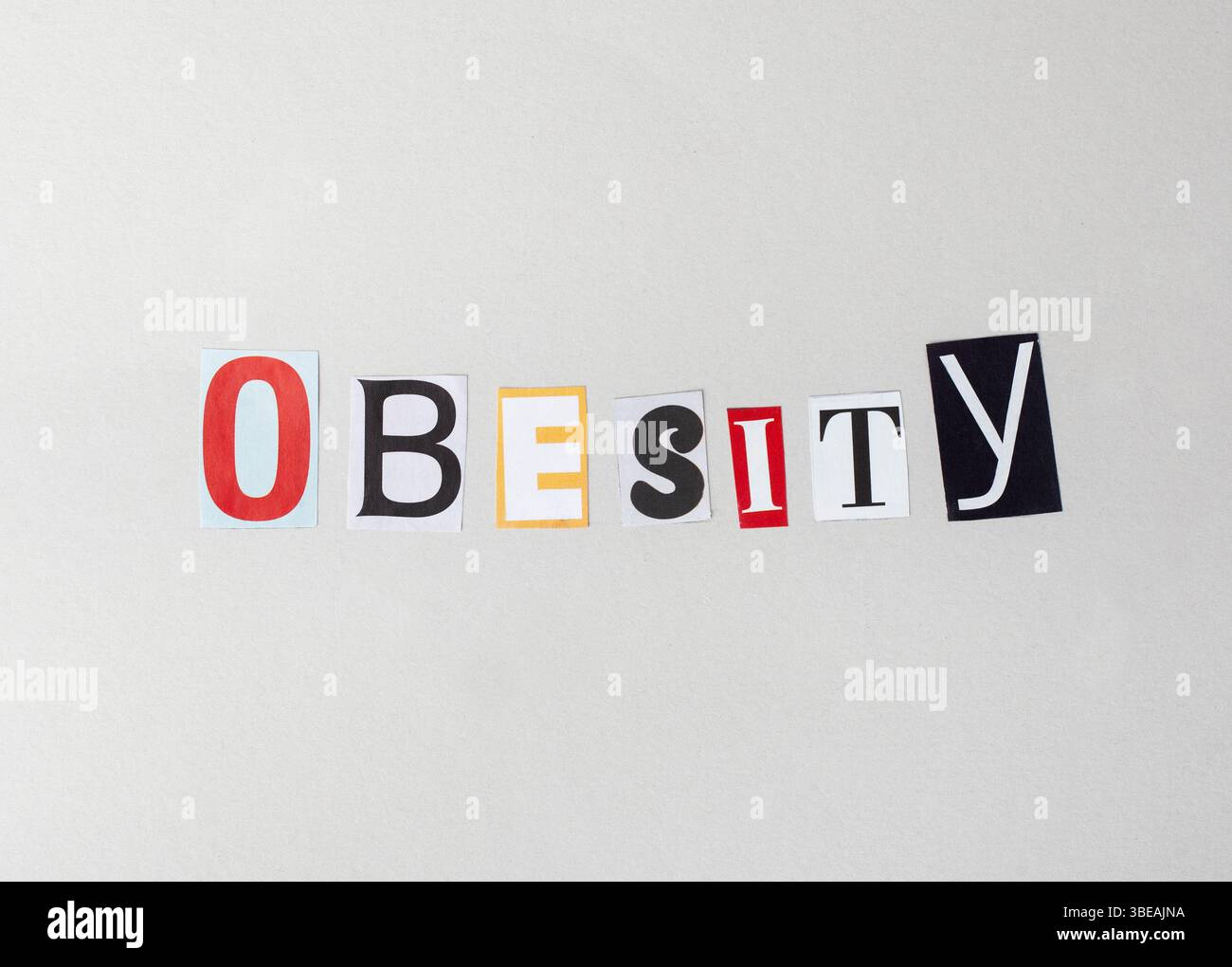 The word obesity is written in a collage of magazine cut outs. magazine ...