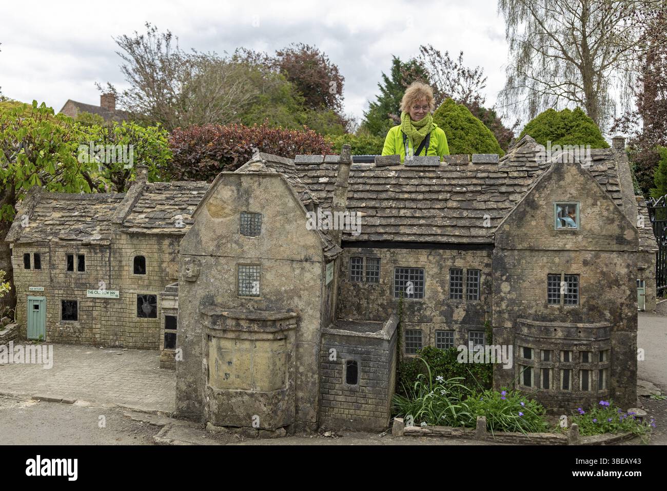 Visitor looking at buildings, miniature village, Bourton-on-the-Water ...