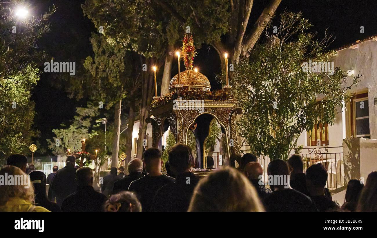 Night scenes of a procession through a tree-lined street with ...