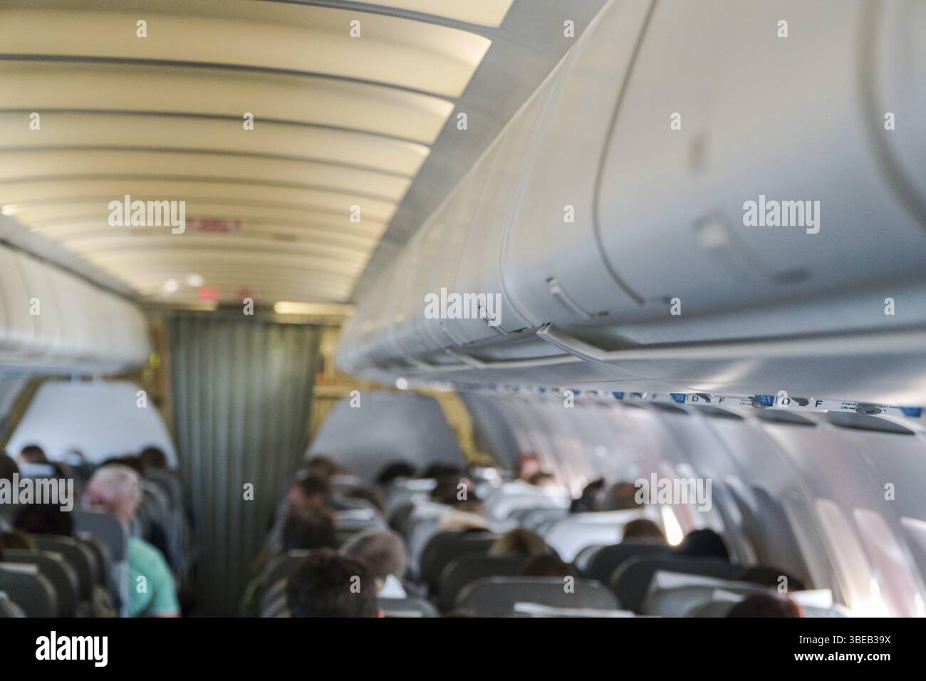 Blurred photo of the aircraft interior. The ceiling of the airplane ...