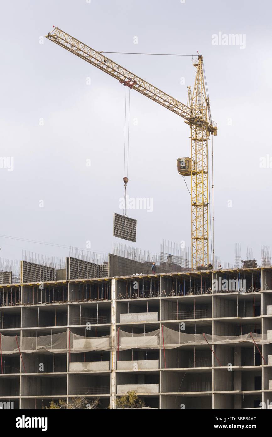 Crane raised formwork on construction of multi-storey residential ...
