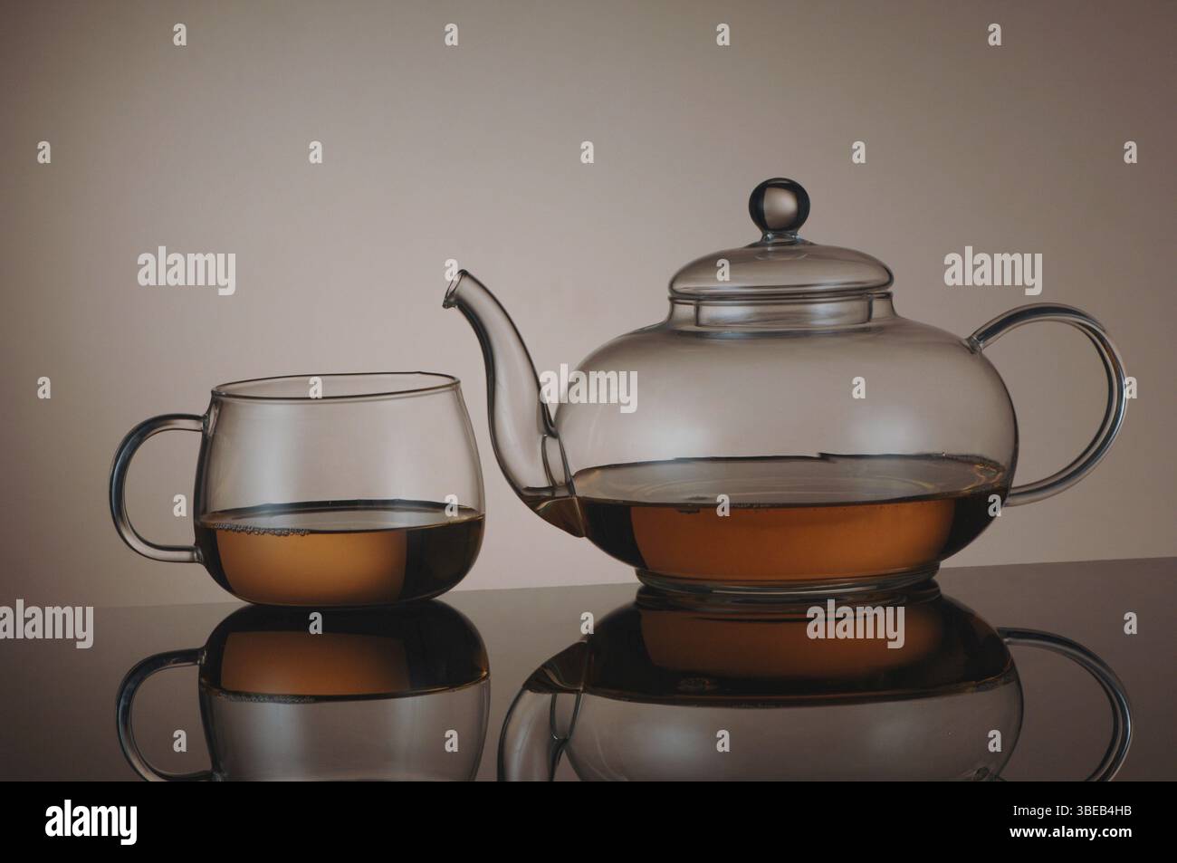 Transparent glass teapot and tea cup with reflection Stock Photo - Alamy