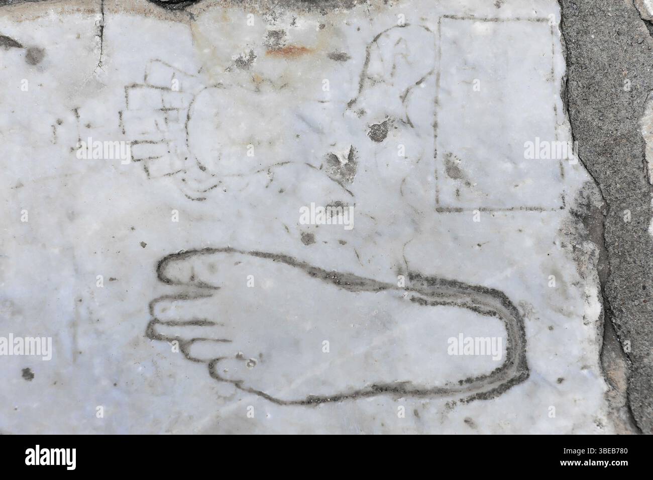 Ancient relief with footprint in marble, Turkey, Ephesus: Tourists ...