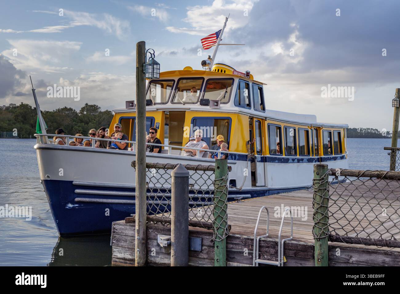Water taxi boat with passengers approaching the dock of Fort Wilderness ...