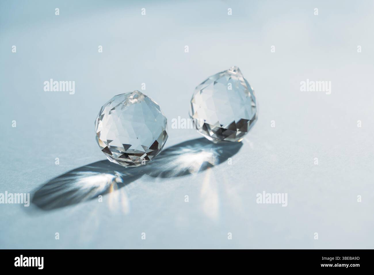 Two crystals with light refraction on blue minimal background Stock ...
