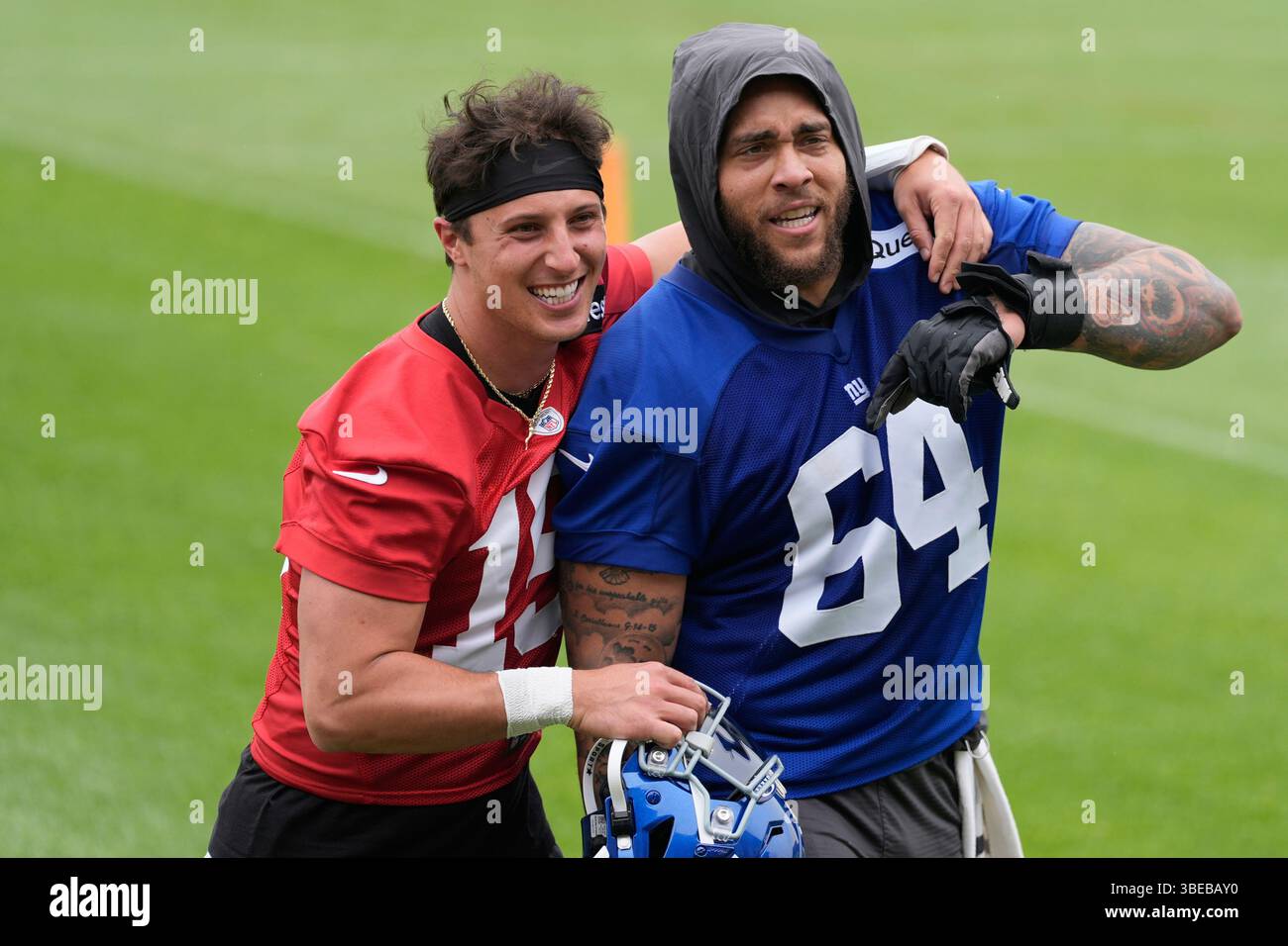 New York Giants quarterback Tommy DeVito, left, and Aaron Stinnie leave ...