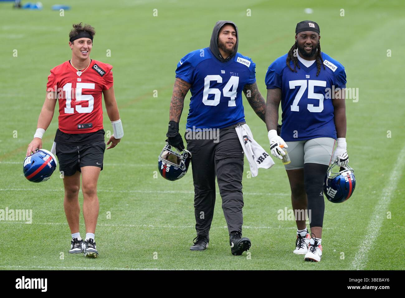 New York Giants quarterback Tommy DeVito, left, Aaron Stinnie, center ...