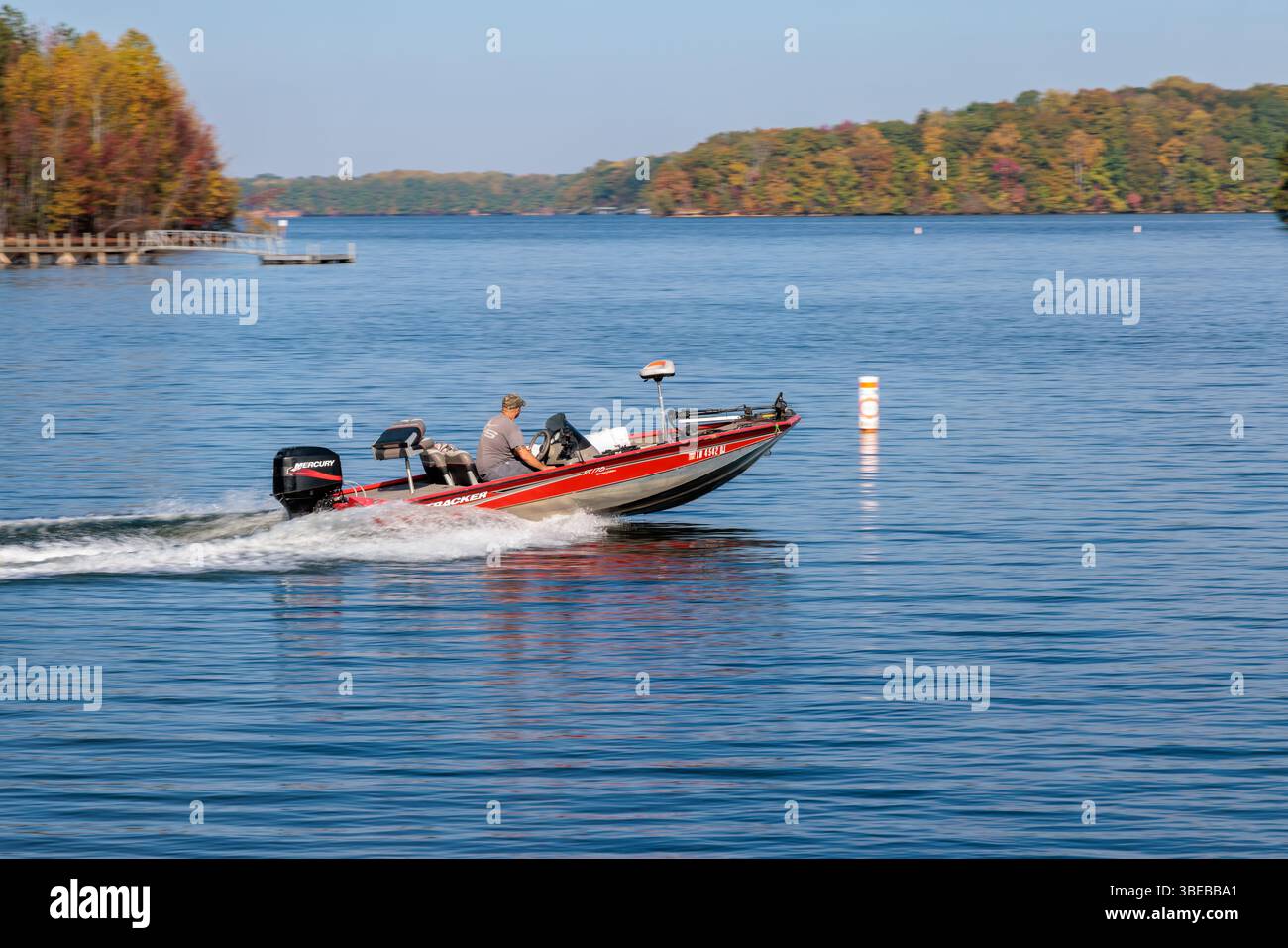 Fisherman driving his fishing boat on Tims Ford Reservoir at Tim's Ford ...