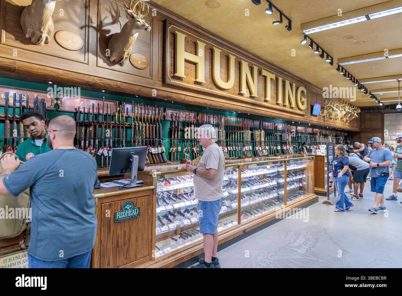Customers shopping for guns at the Hunting counter inside the Bass Pro ...
