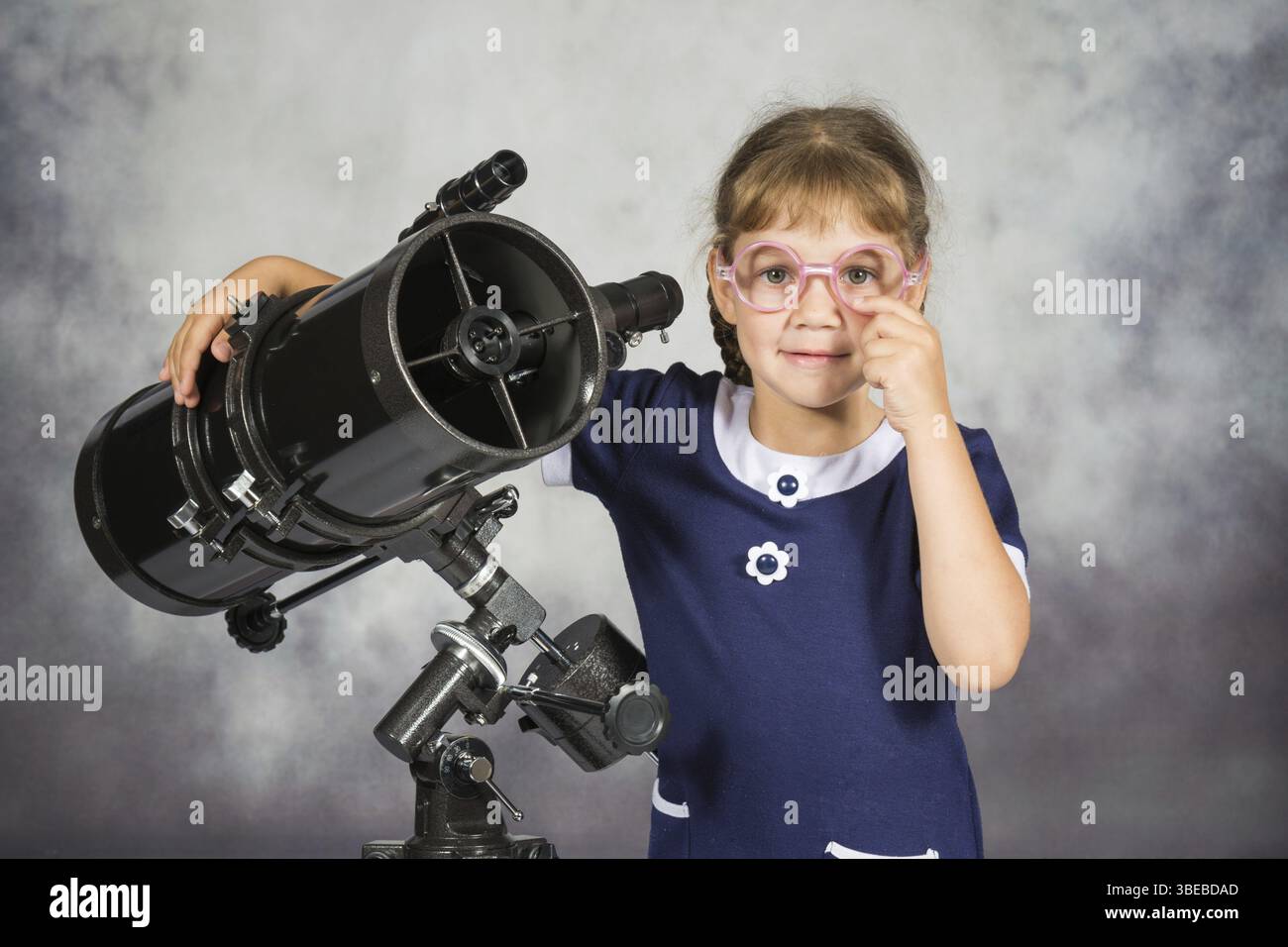 Girl astronomer happily surprised by what he saw in the telescope Stock ...
