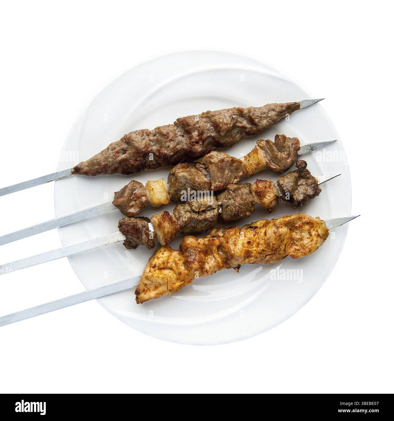 Kebab on skewers in a plate on a white background. Top view. Isolated ...