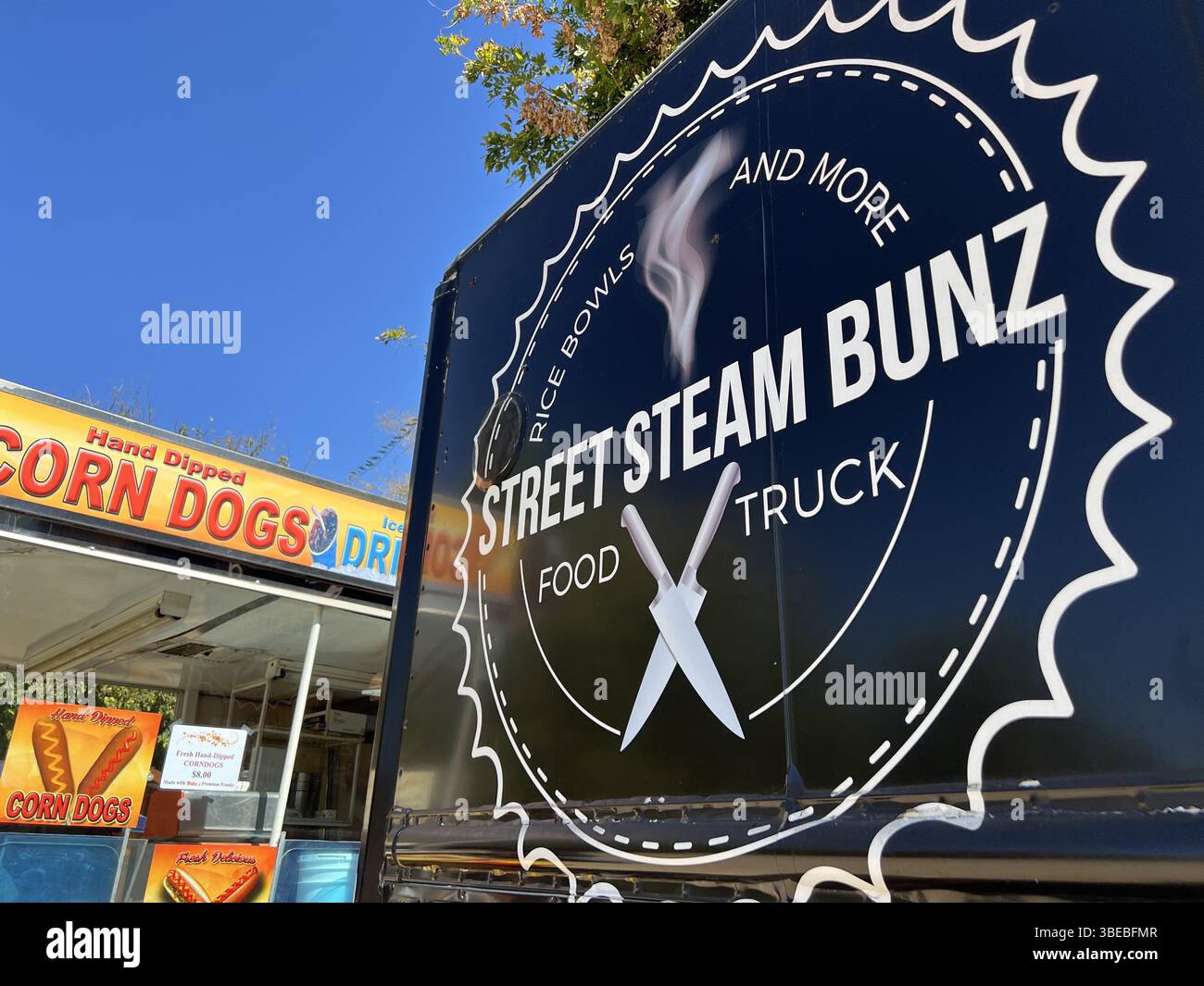 Food truck with "Street Steam Bunz" signage next to a stand offering ...