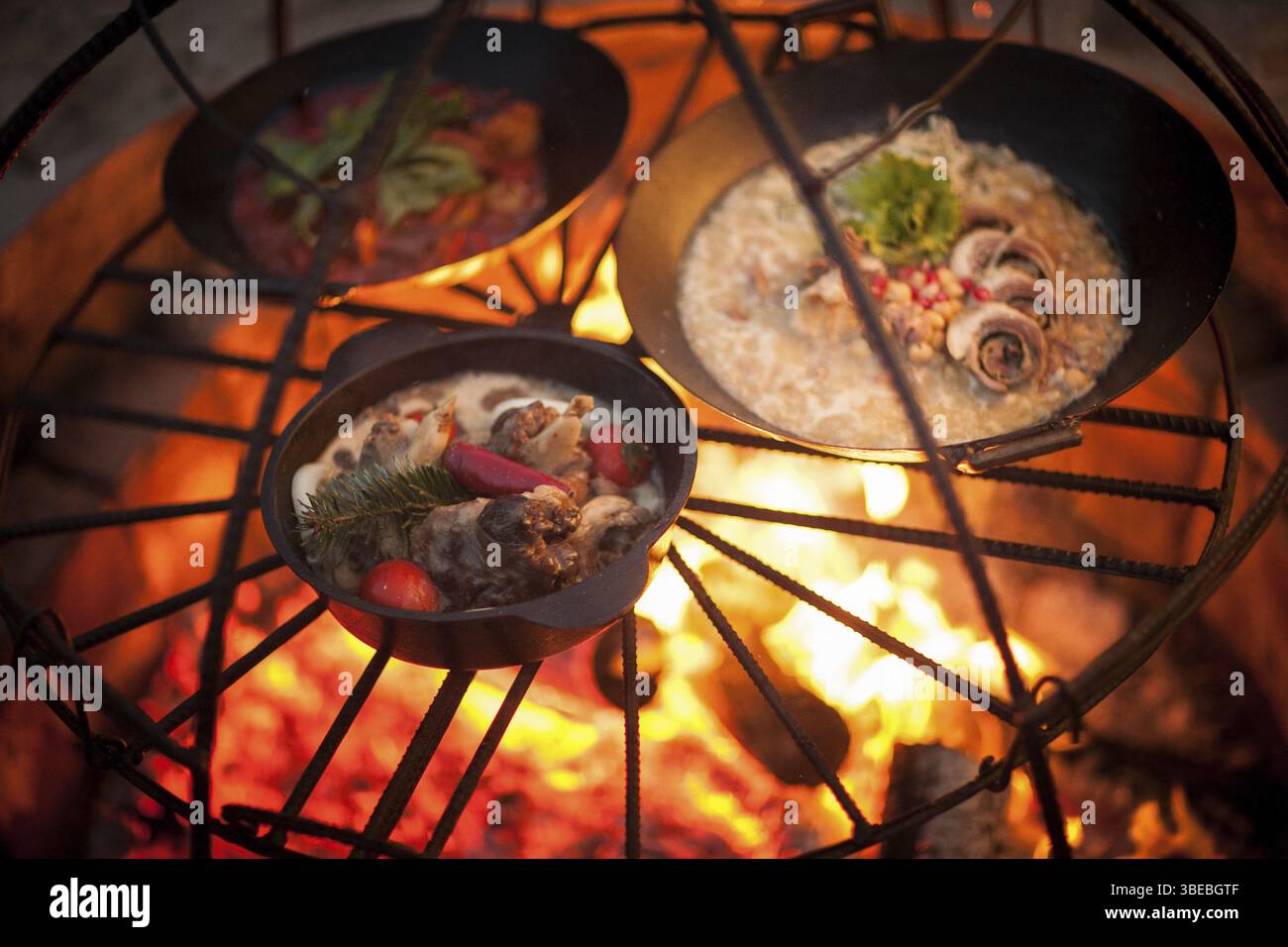 Cooking meat dishes on fire Stock Photo - Alamy