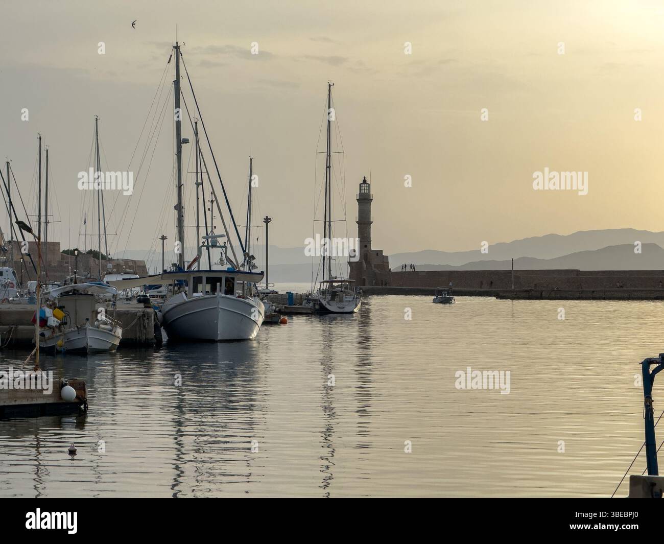 Crete, Chania old harbour. Waterfront buildings at sunset, old ...