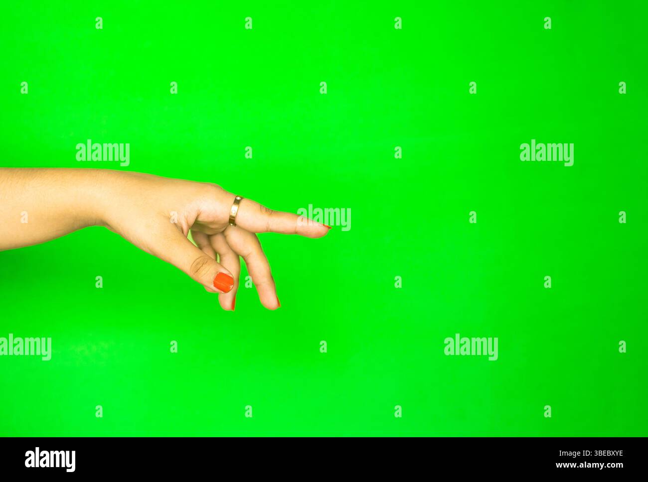 A hand extending forward in a subtle reaching pose on a plain green ...