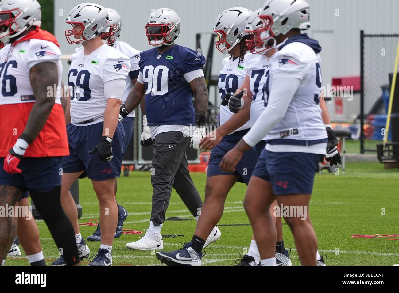 New England Patriots defensive tackle Christian Barmore (90) walks with ...
