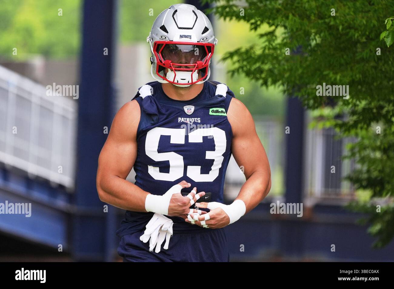 New England Patriots linebacker Christian Elliss (53) tapes his fingers ...