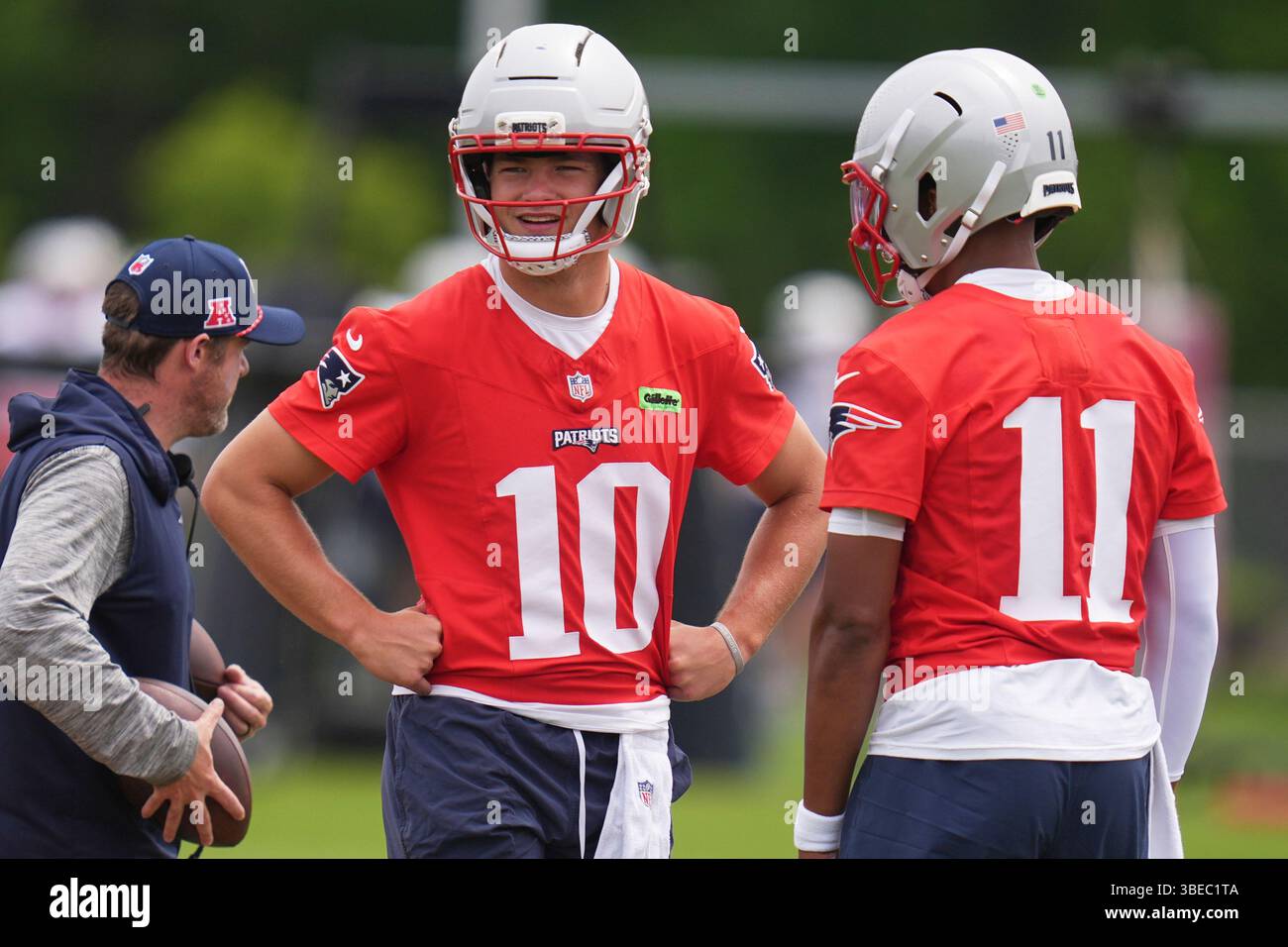 New England Patriots quarterback Drake Maye (10) talks with quarterback ...
