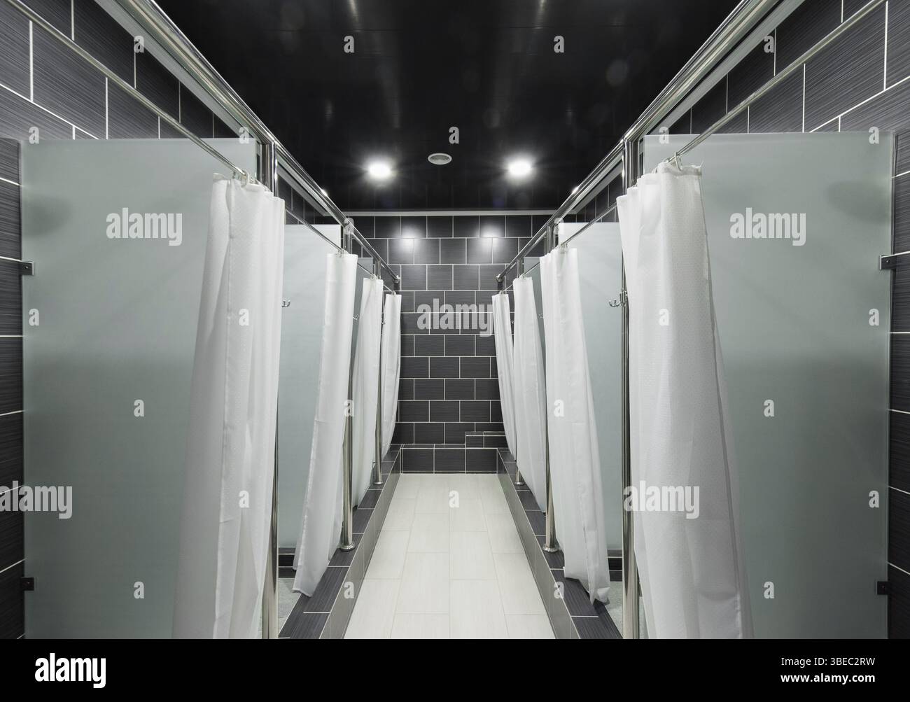 Public shower room with curtains in the booths Stock Photo - Alamy