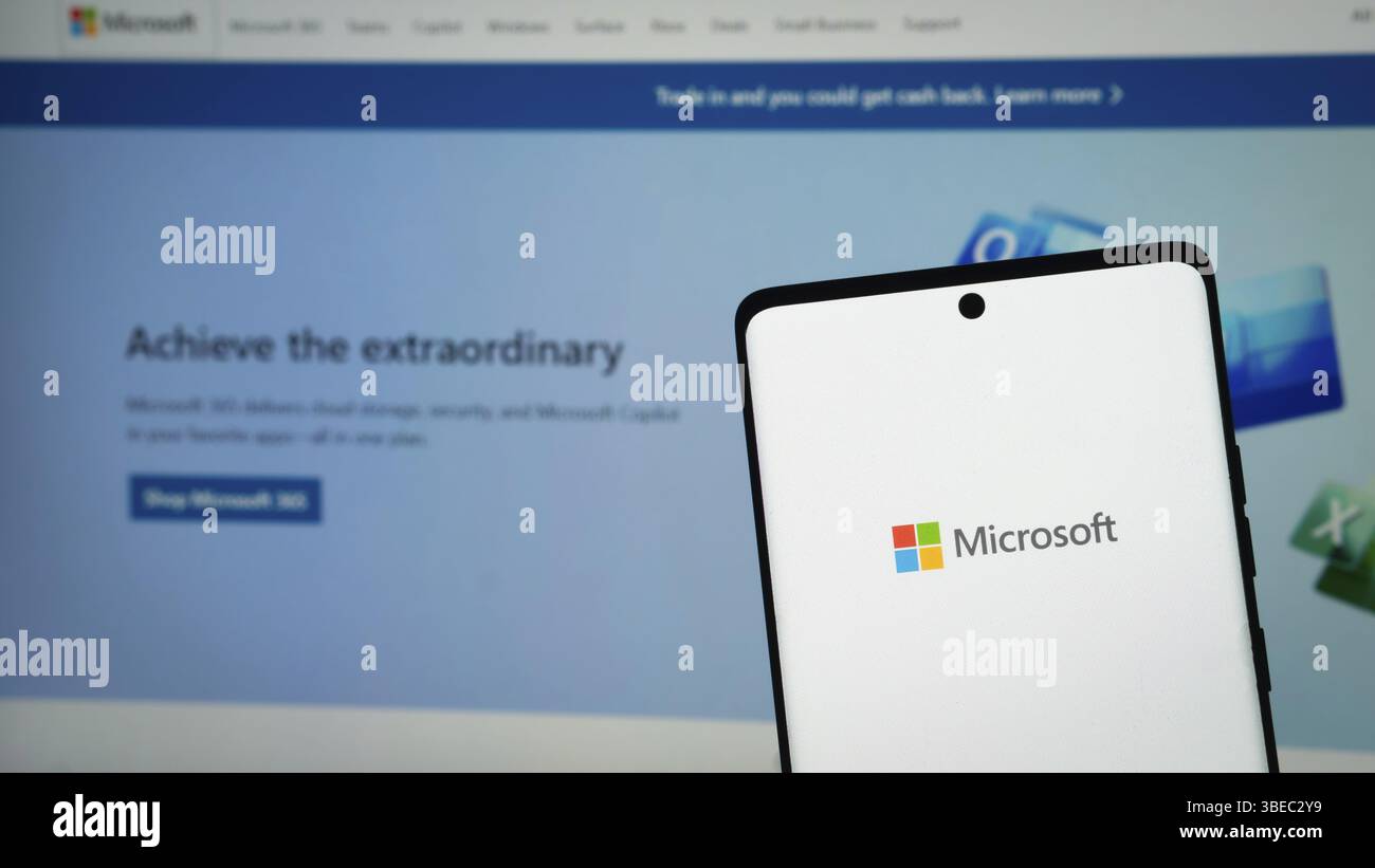 Smartphone with Microsoft logo in front of a business-themed website ...
