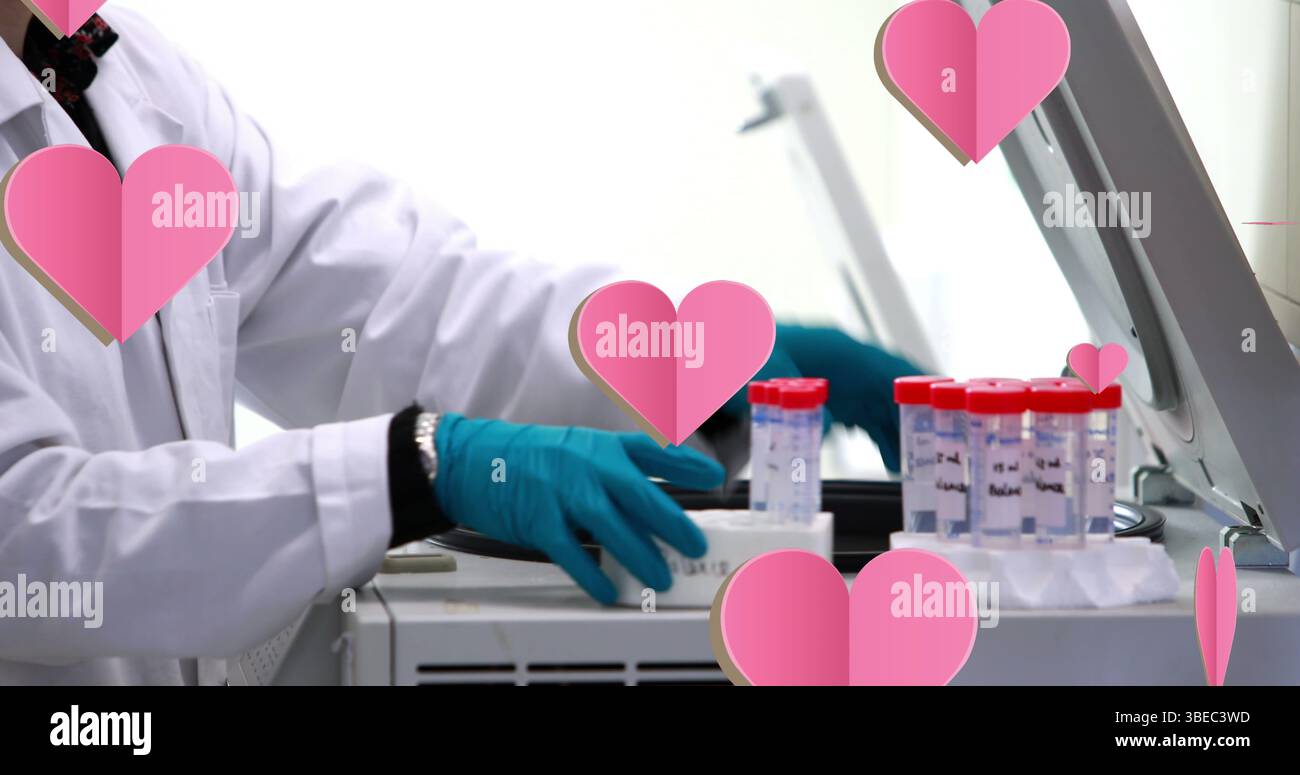 Image of falling hearts over scientist in laboratory Stock Photo - Alamy