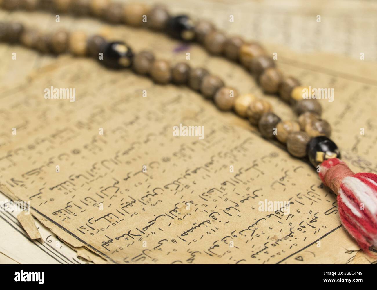 Muslim prayer beads with ancient pages from the Koran. Islamic and ...