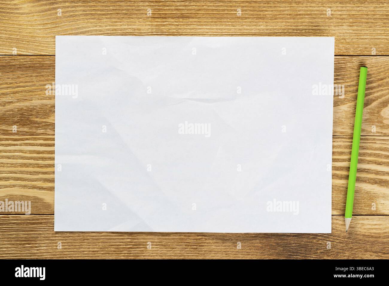 Sheet of paper lying on wooden table. Blank white a4 format paper with ...