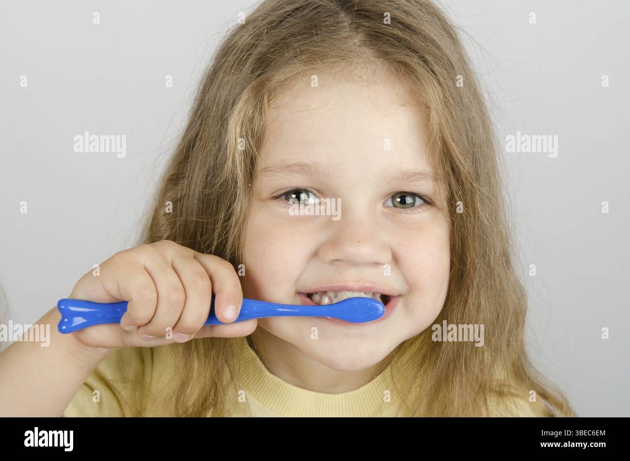 Two girls of four and six years of brushing their teeth toothbrushes ...