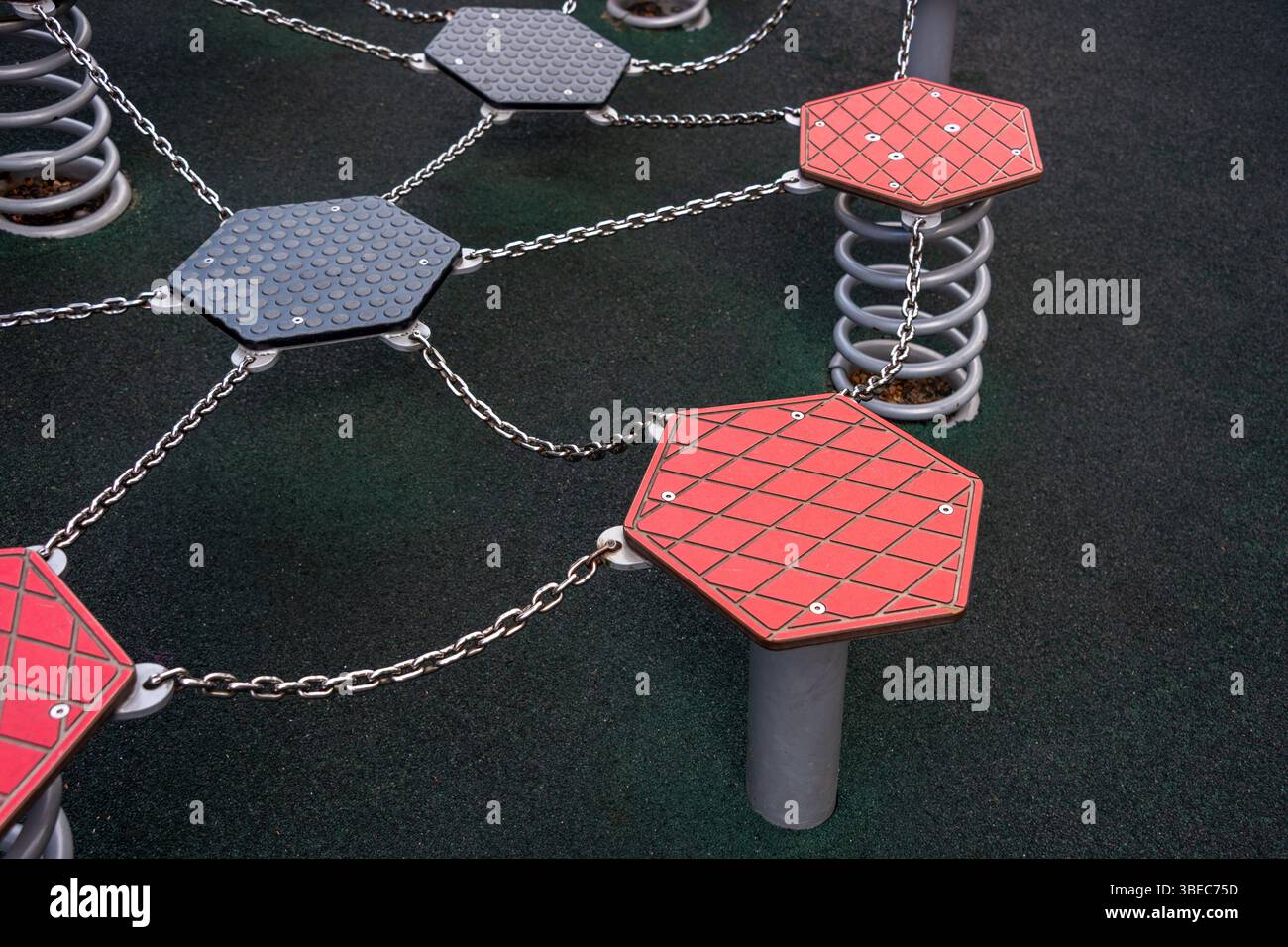 Modern playground apparatus with hexagonal platforms, springs, and ...
