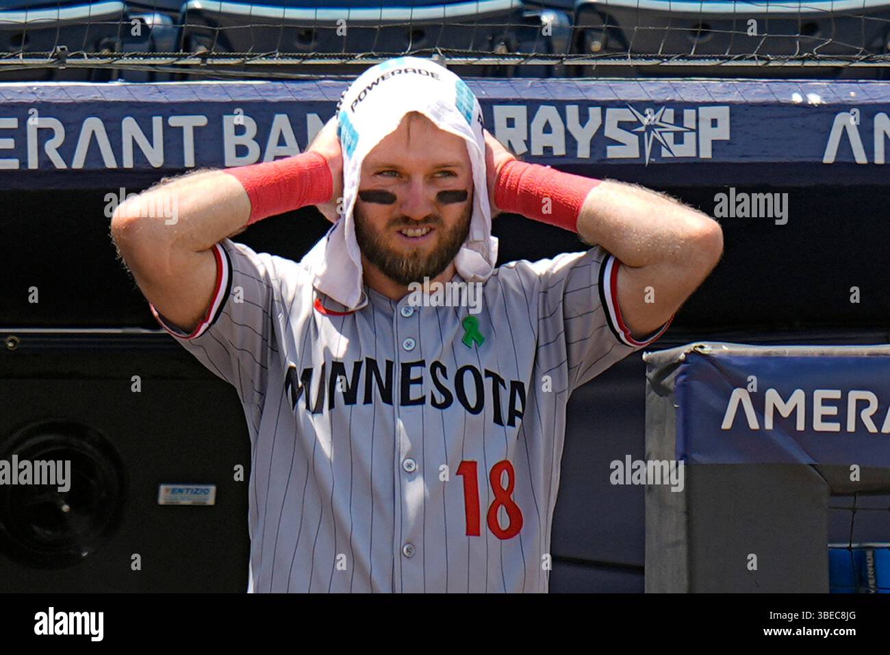 Minnesota Twins' Kody Clemens covers his head to avoid the heat during ...
