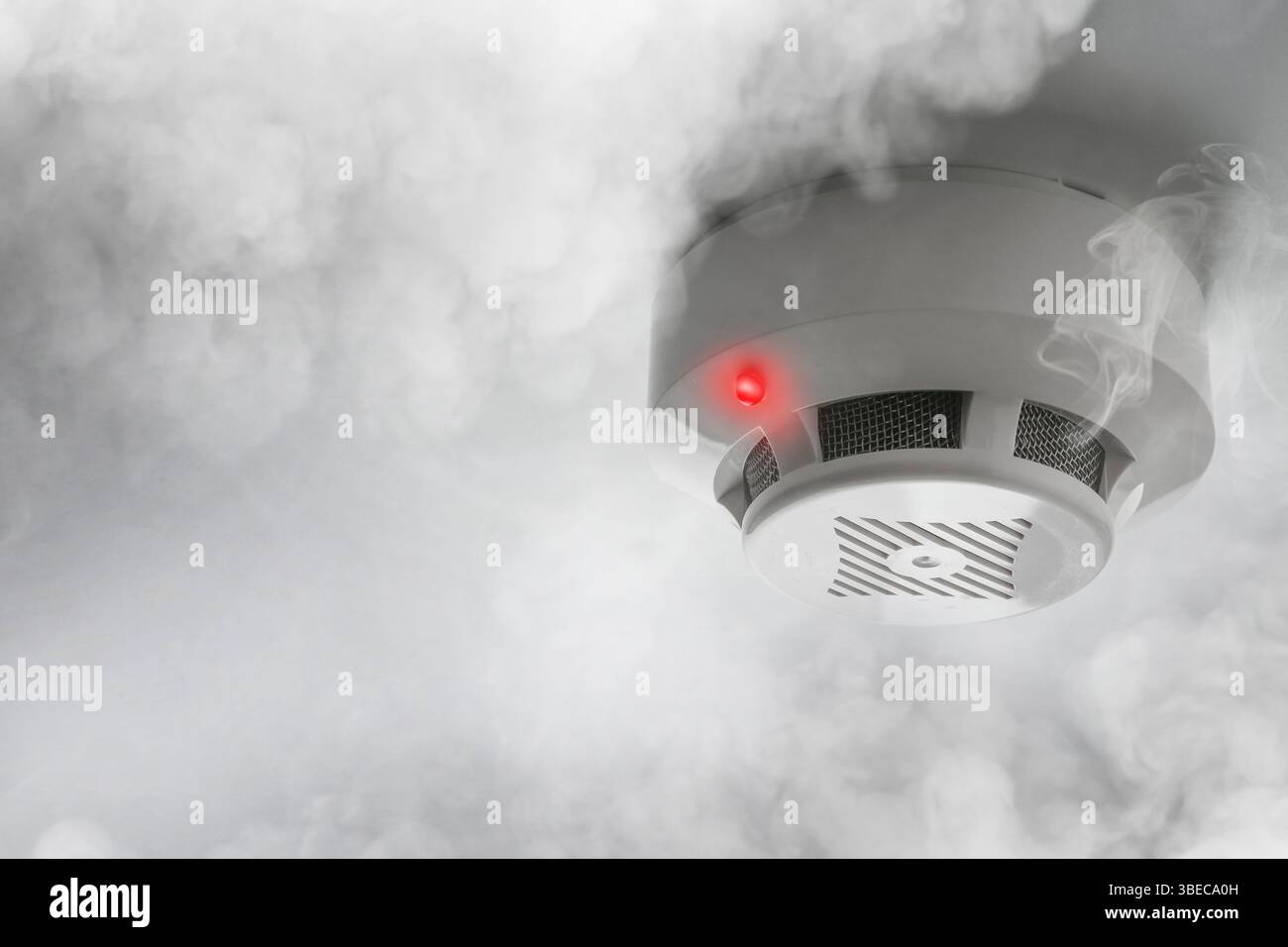 Fire alarm system detector on ceiling triggered by smoke Stock Photo ...