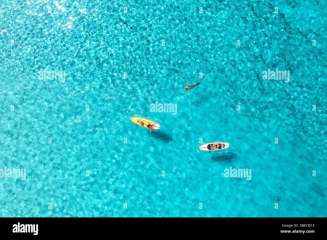 Aerial view of kayaks in blue sea at sunset in summer. Man on floating ...