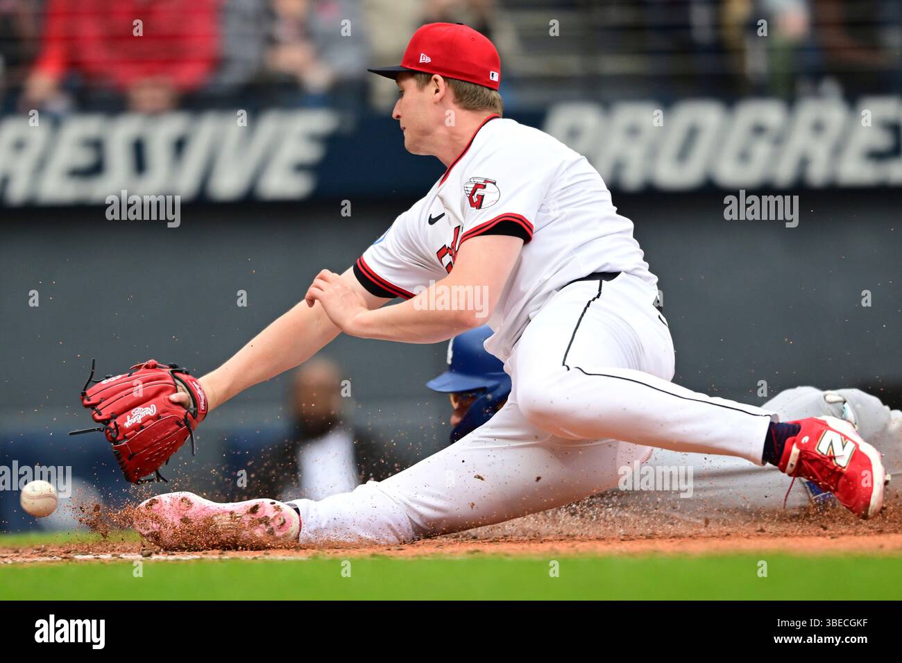 Cleveland Guardians relief pitcher Tim Herrin reaches for the ball as ...
