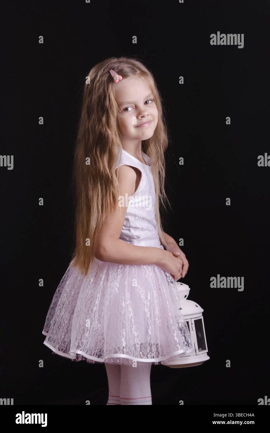 Five year old girl standing with a candlestick Stock Photo - Alamy