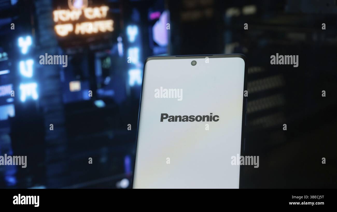 Panasonic logo on a mobile screen against a backdrop of neon lights ...