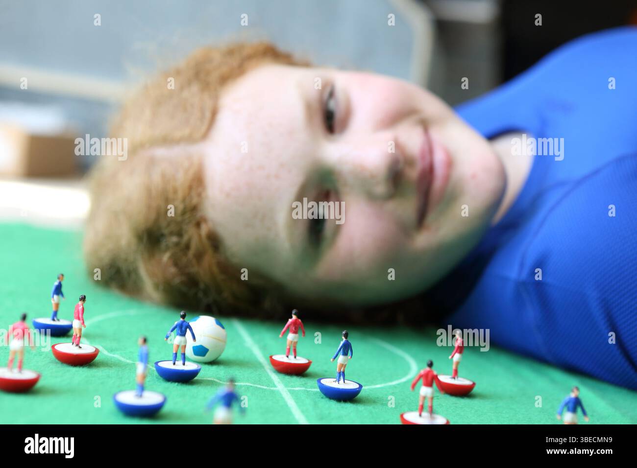 Girl lying on cloth pitch with Subbuteo football figures Stock Photo ...