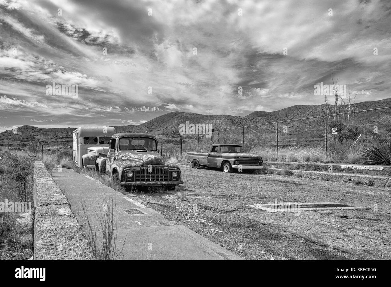 black and white image of antique cars sitting on the sode of the road ...