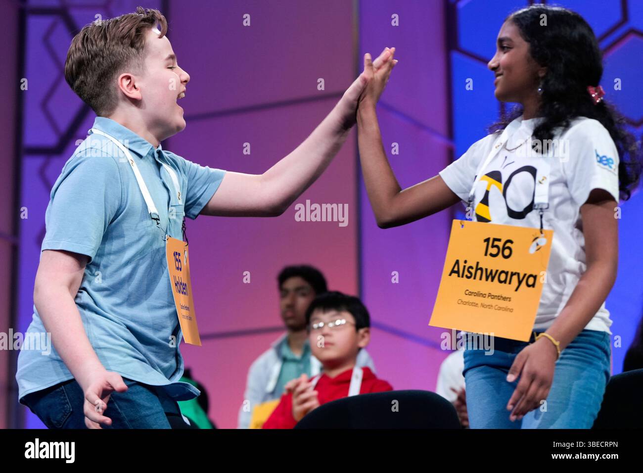 Holden Connor Good, 13, left, high fives Aishwarya Kallakuri, 14, of ...