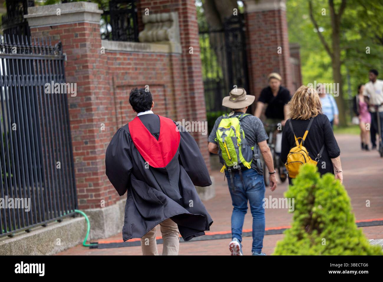 Cambridge, Massachusetts, USA. 28th May, 2025. A graduate walks past ...